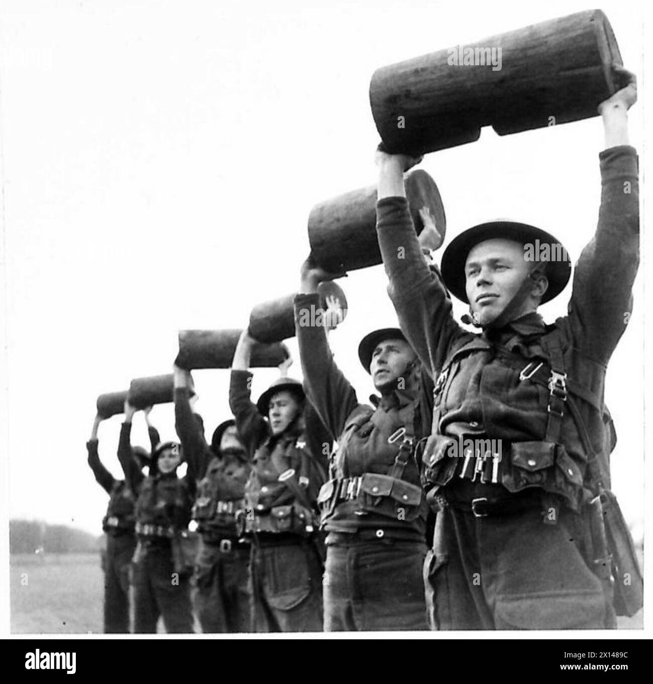 TOUGHENING UP - Men doing exercises with heavy wooden logs to make ...