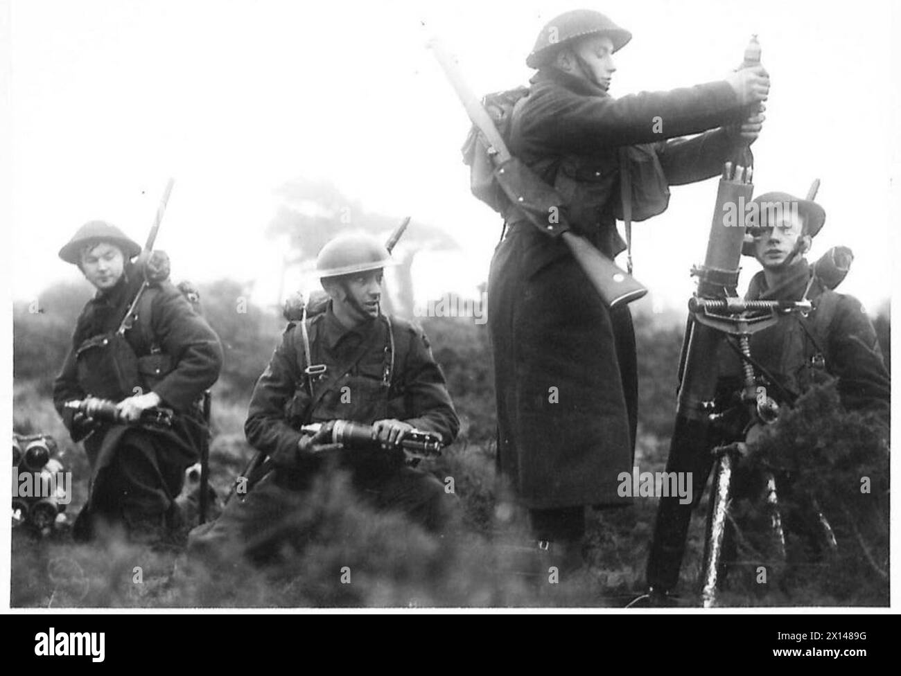 EAST YORKS IN TRAINING - Projectiles being loaded in trench mortars ...