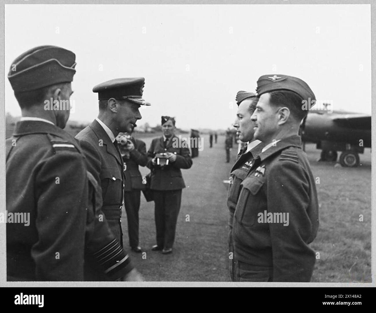 The King speaks with Group Captain L.W. Cannon, the Senior Air Officer ...
