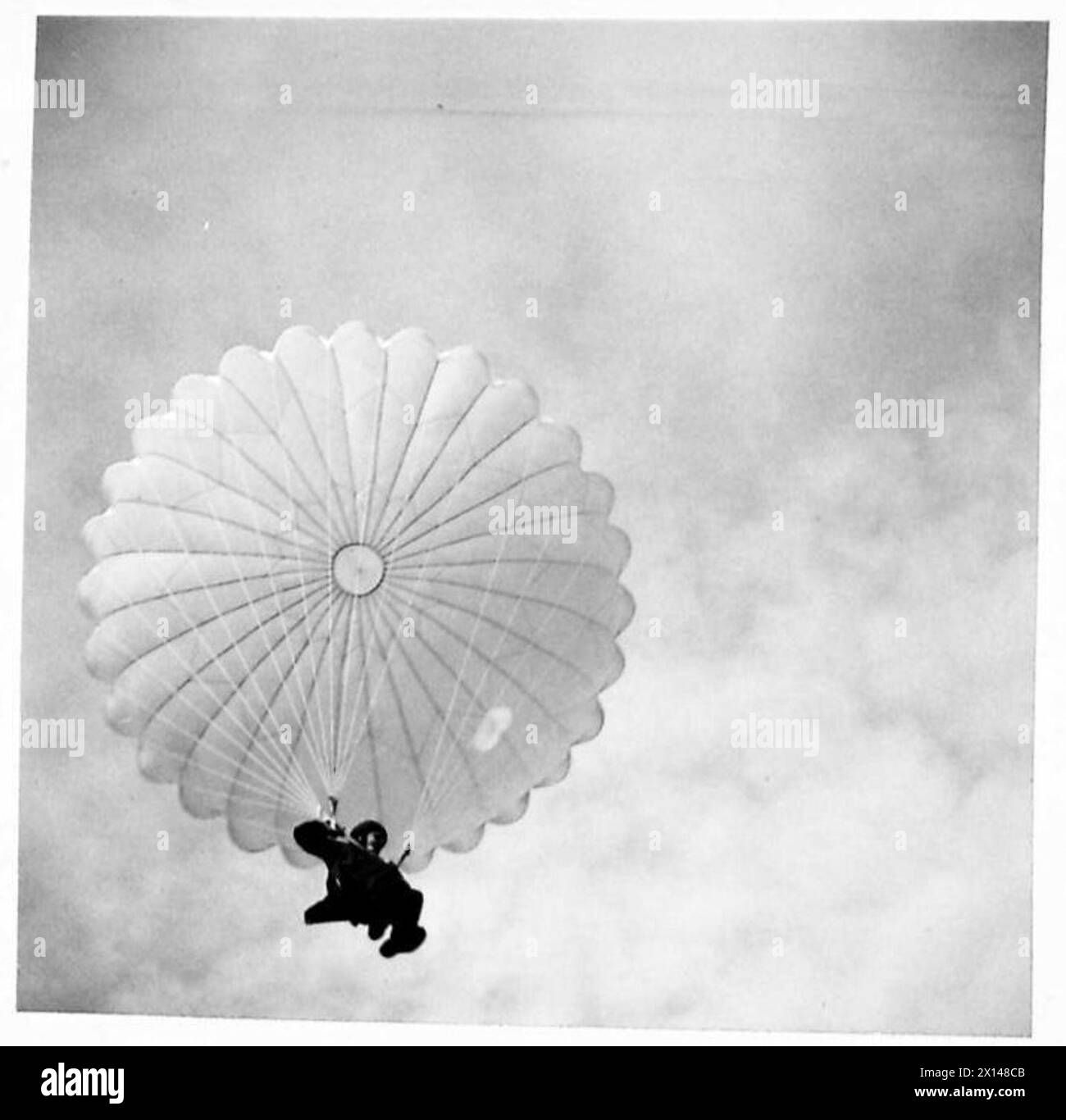 Paratroop recruits are captured mid-air during early training jumps ...