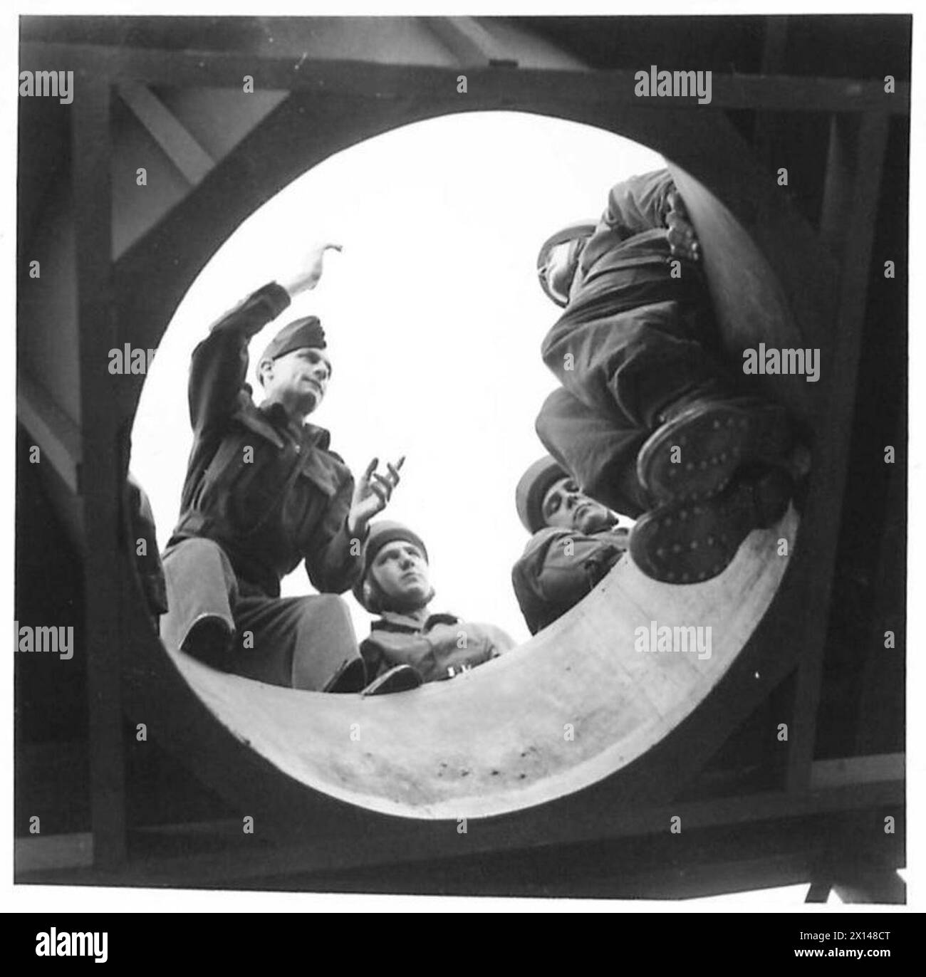 Paratroops are shown learning to exit correctly using a full-scale ...