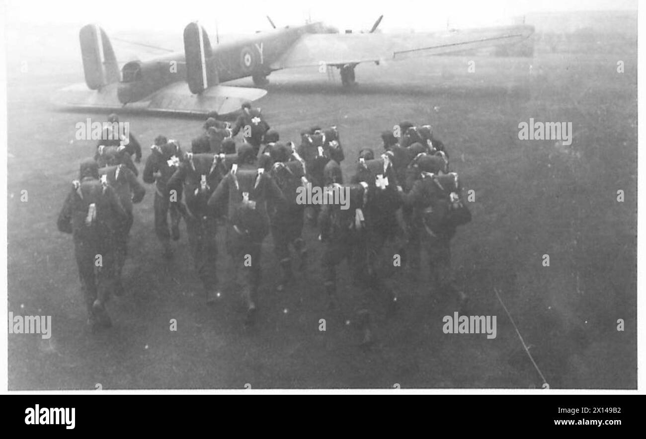 Parachute troops run towards fellow soldiers who are moving aircraft ...