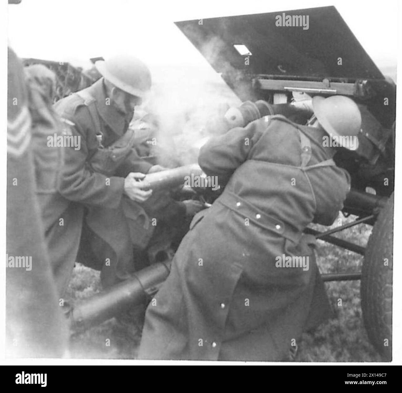 A Home Guard unit operates and fires an 18-pounder field gun during ...