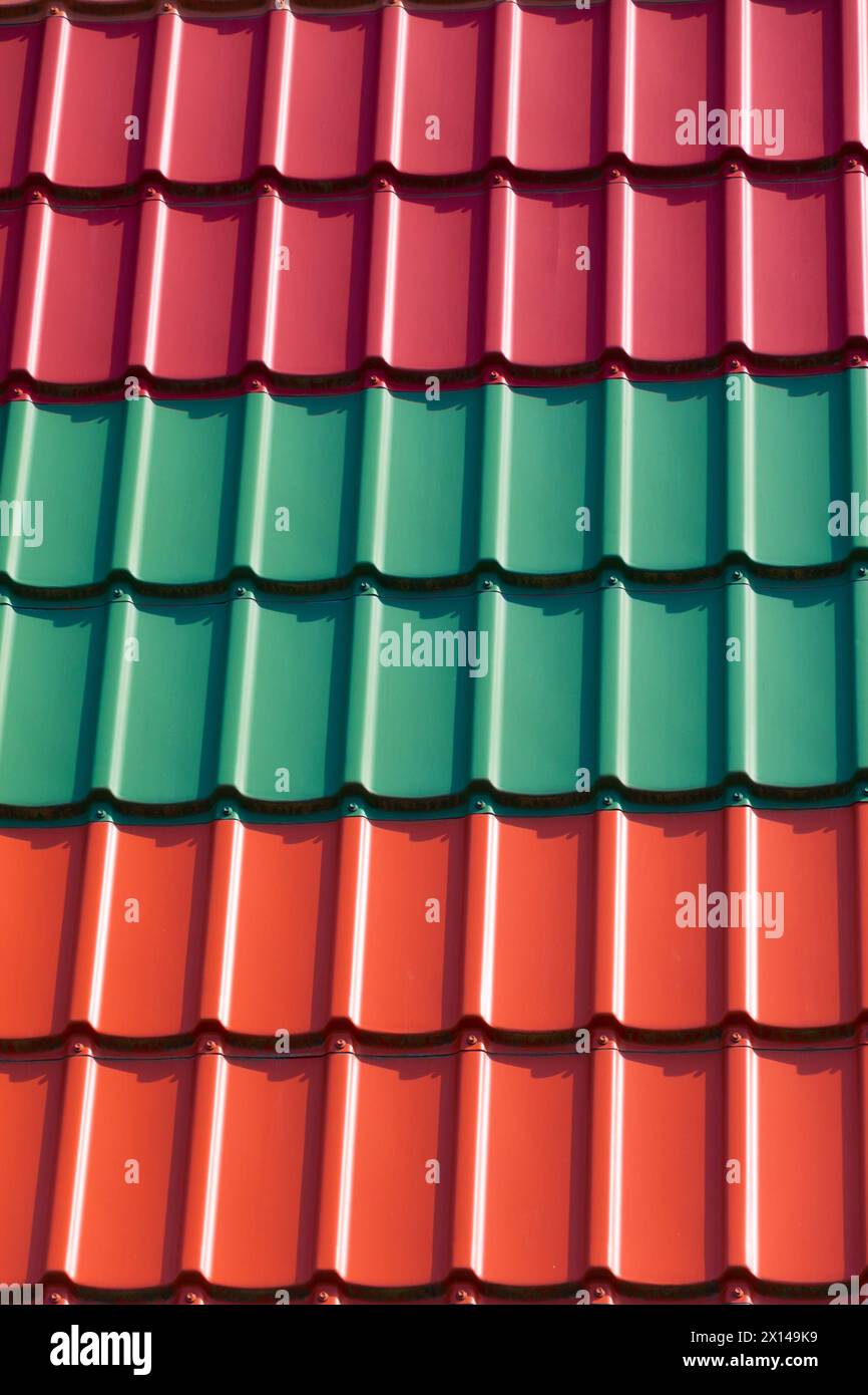Multi-colored tiles on the roof of a building. Construction Materials ...
