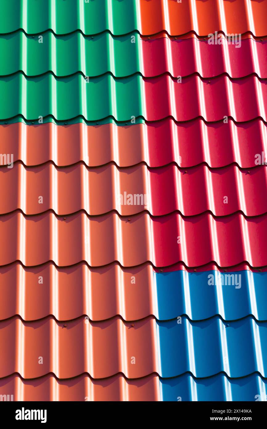 Multi-colored tiles on the roof of a building. Construction Materials ...