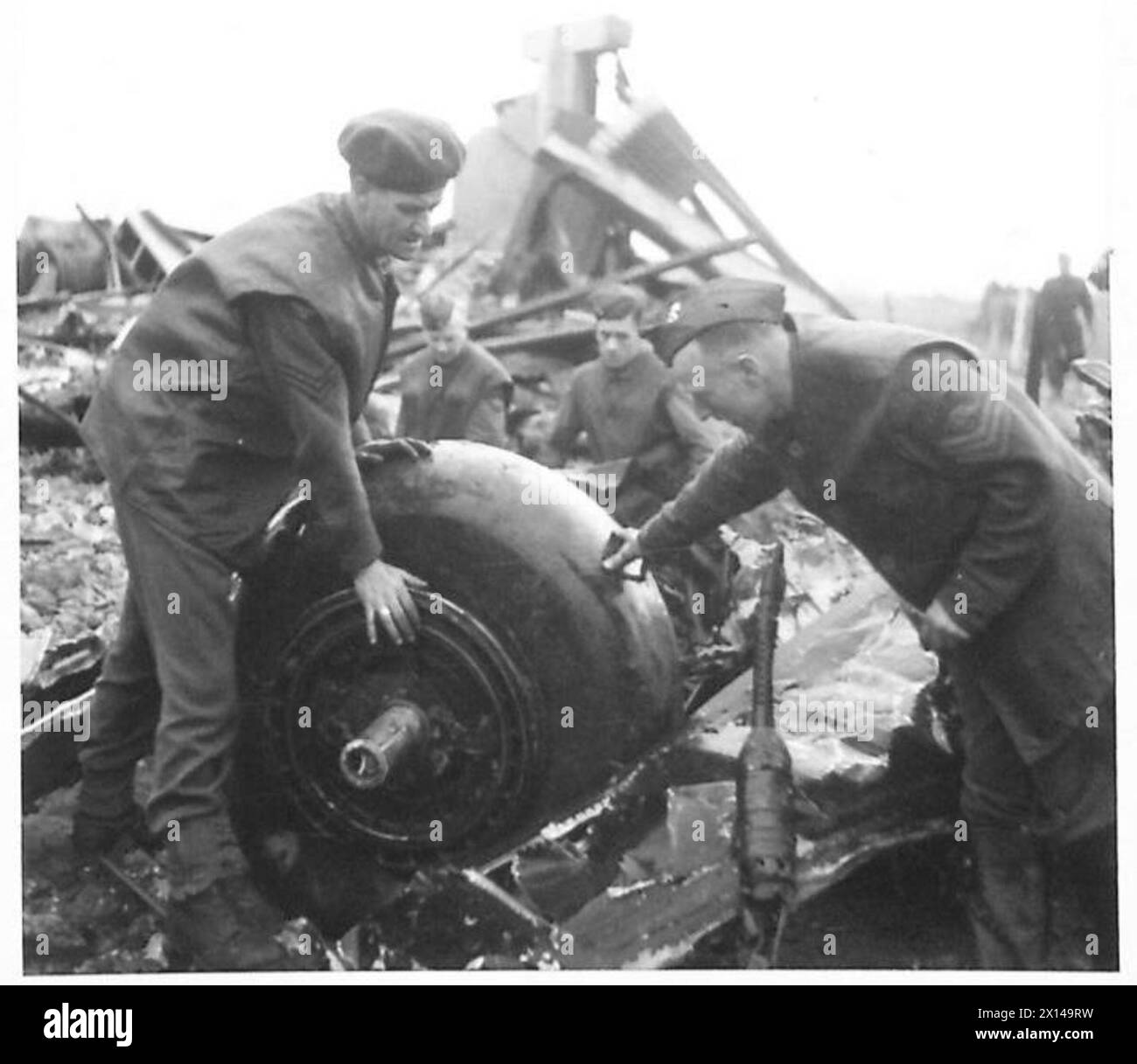 Anti-aircraft gunners inspect the wreckage of a German raider destroyed ...
