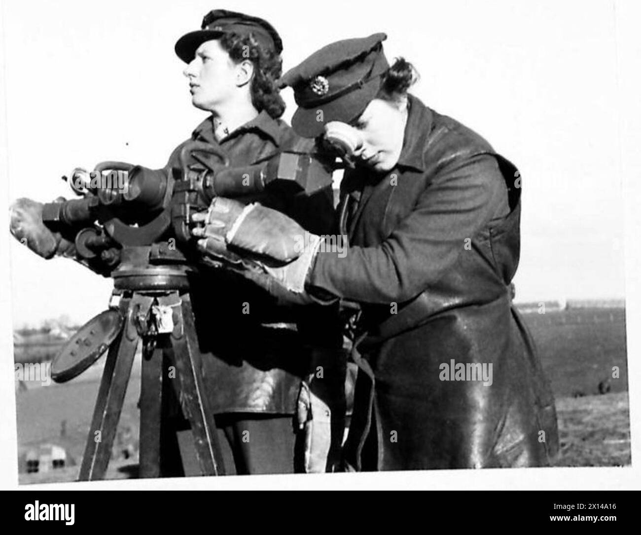 MIXED A. A. BATTERY IN BELGIUM - A.T.S. operate the telescope indicator. Left to right - Private ...