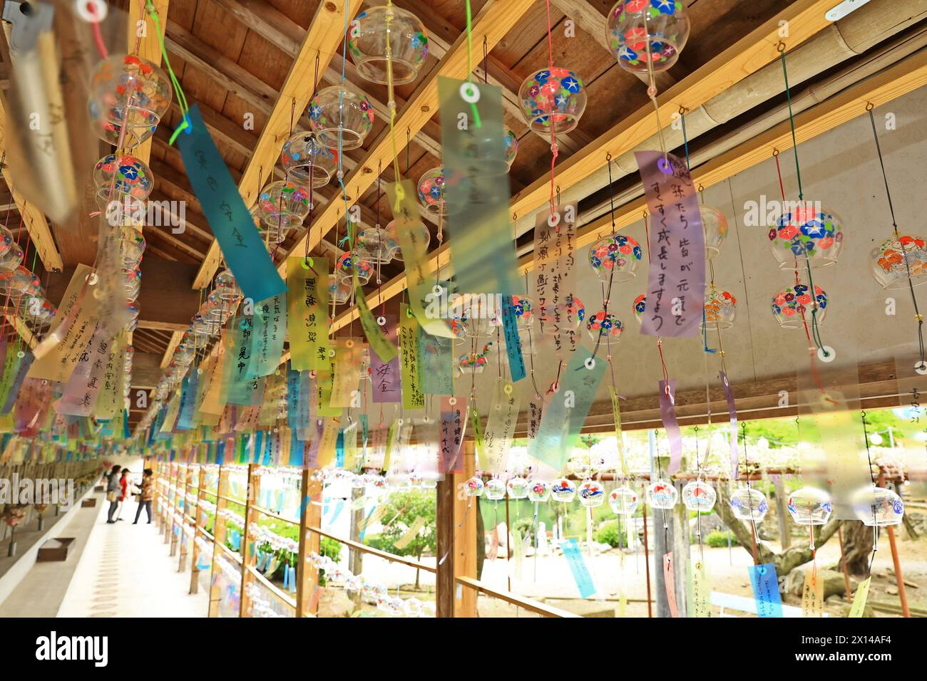Many wind chimes are hung in the corridor and swaying in the wind at ...