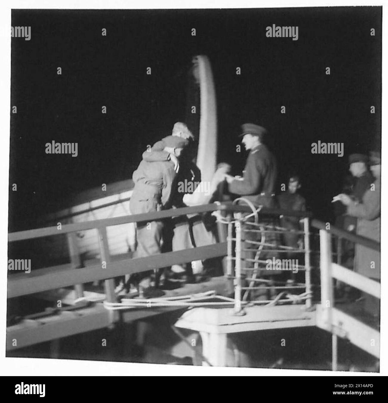 A wounded German prisoner of war is carried aboard a hospital ship for ...