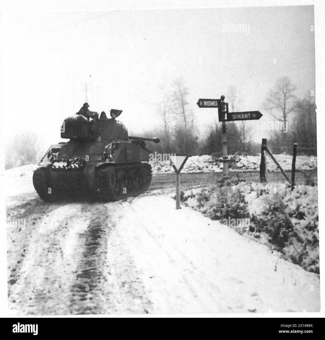 Sherman tanks of the 11th Armoured Division move through snow and mist ...