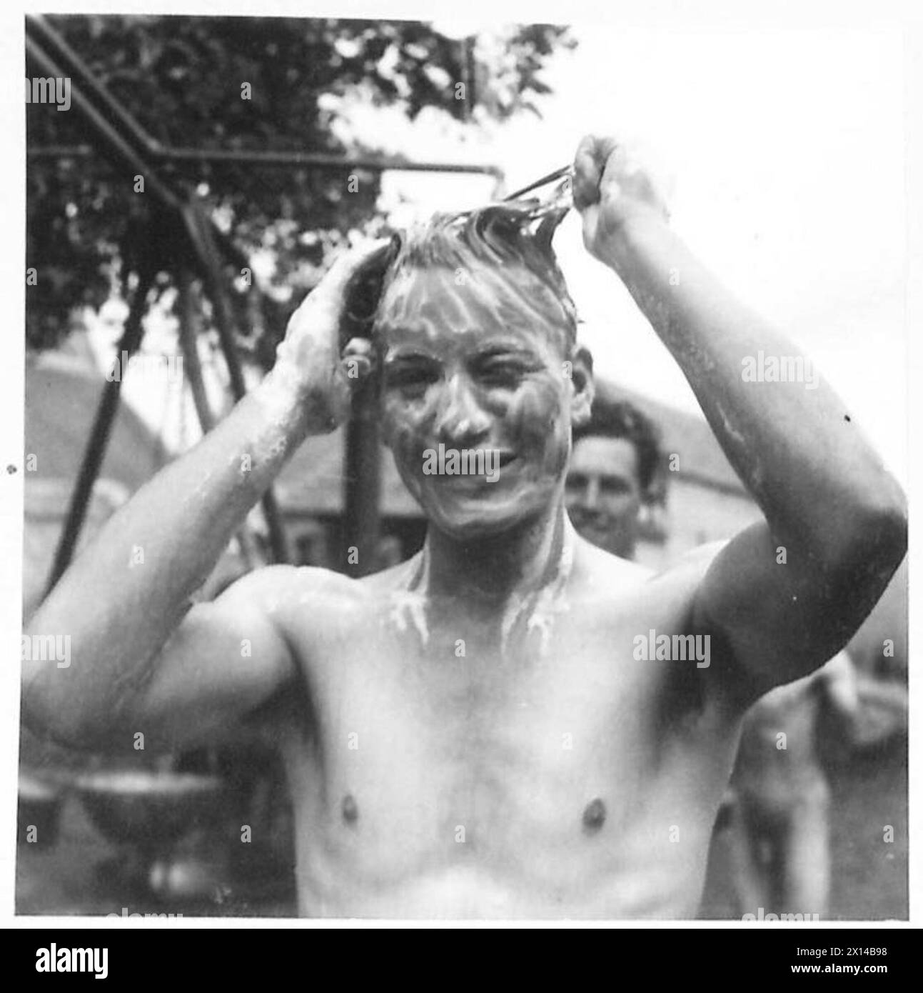 Rifleman Denis Dmith bathes under a shower at a mobile bath unit ...