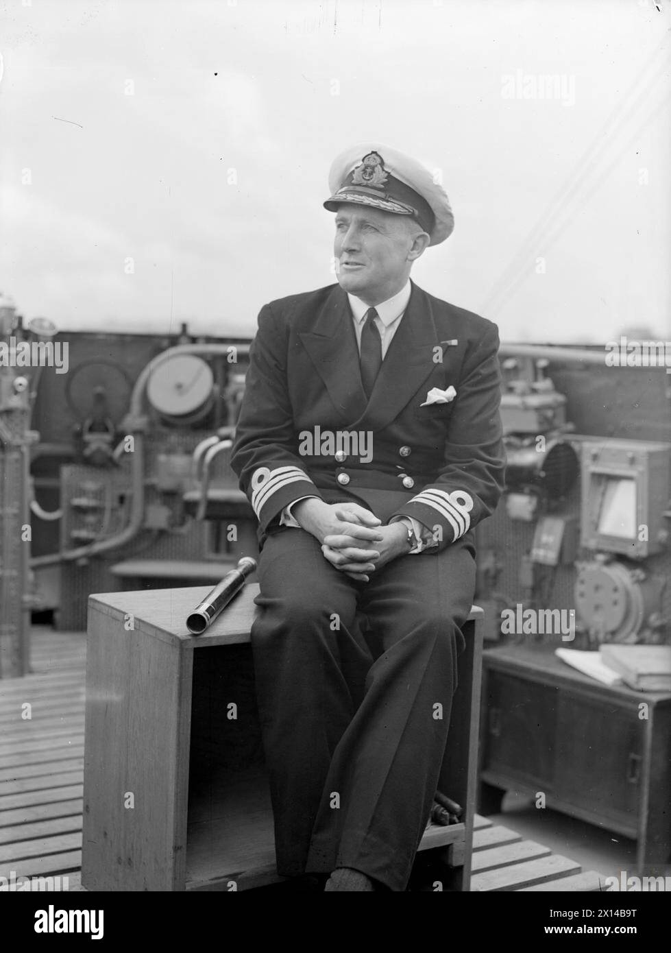 In August 1945, Commander H. T. Powell, RN, is pictured on the bridge ...
