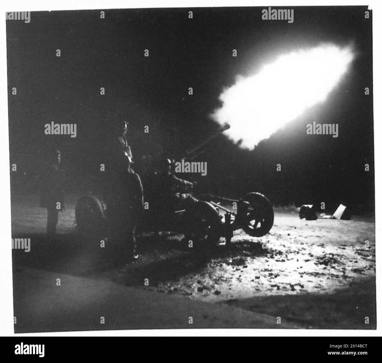 An anti-aircraft gun is operated at night during military exercises ...
