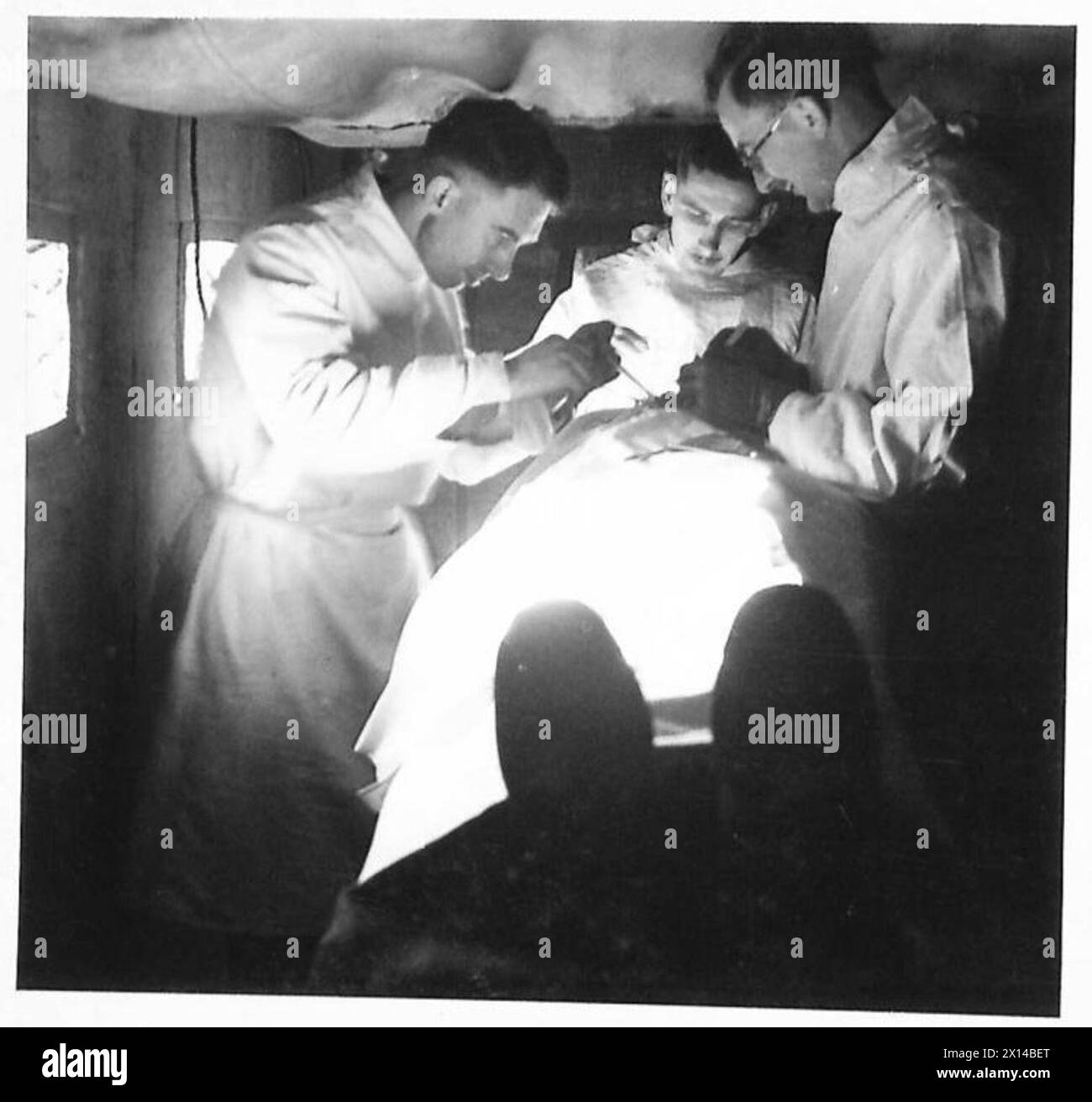 A FIELD AMBULANCE UNIT IN BATTLE TRAINING - A scene in the operating ...