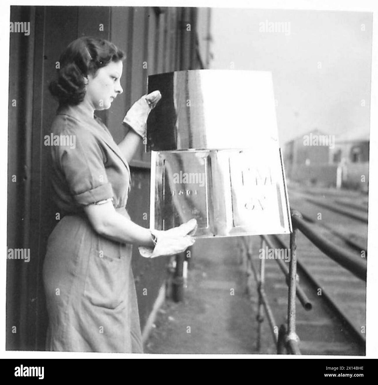 At the Neath base petrol filling depot, tin sheets are stamped to form ...