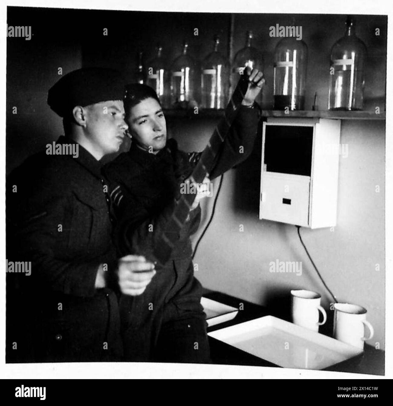 Army Film Unit cameramen carry still cameras for press photography ...