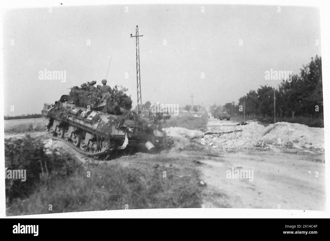 NORMANDY - VARIOUS - Tanks bypass a bomb crater during an advance ...