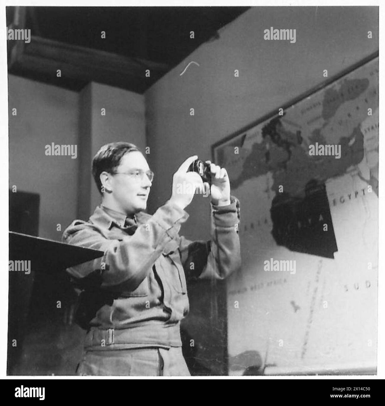 The Chief cameraman of the Army Film Unit measuring light on set ...