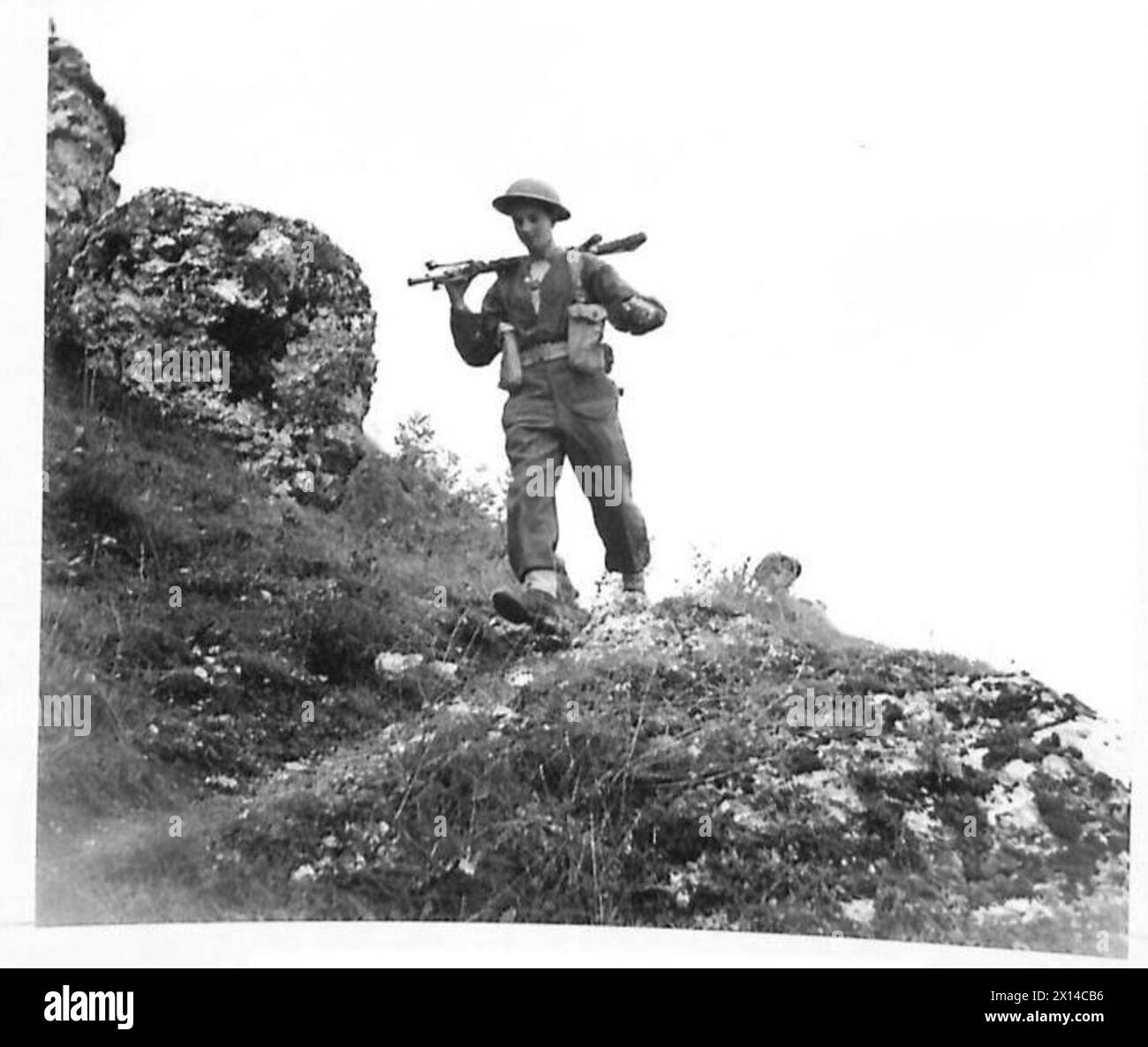 Eighth Army infantrymen advance over a rocky path in Italy, demonstrating maneuver and movement ...