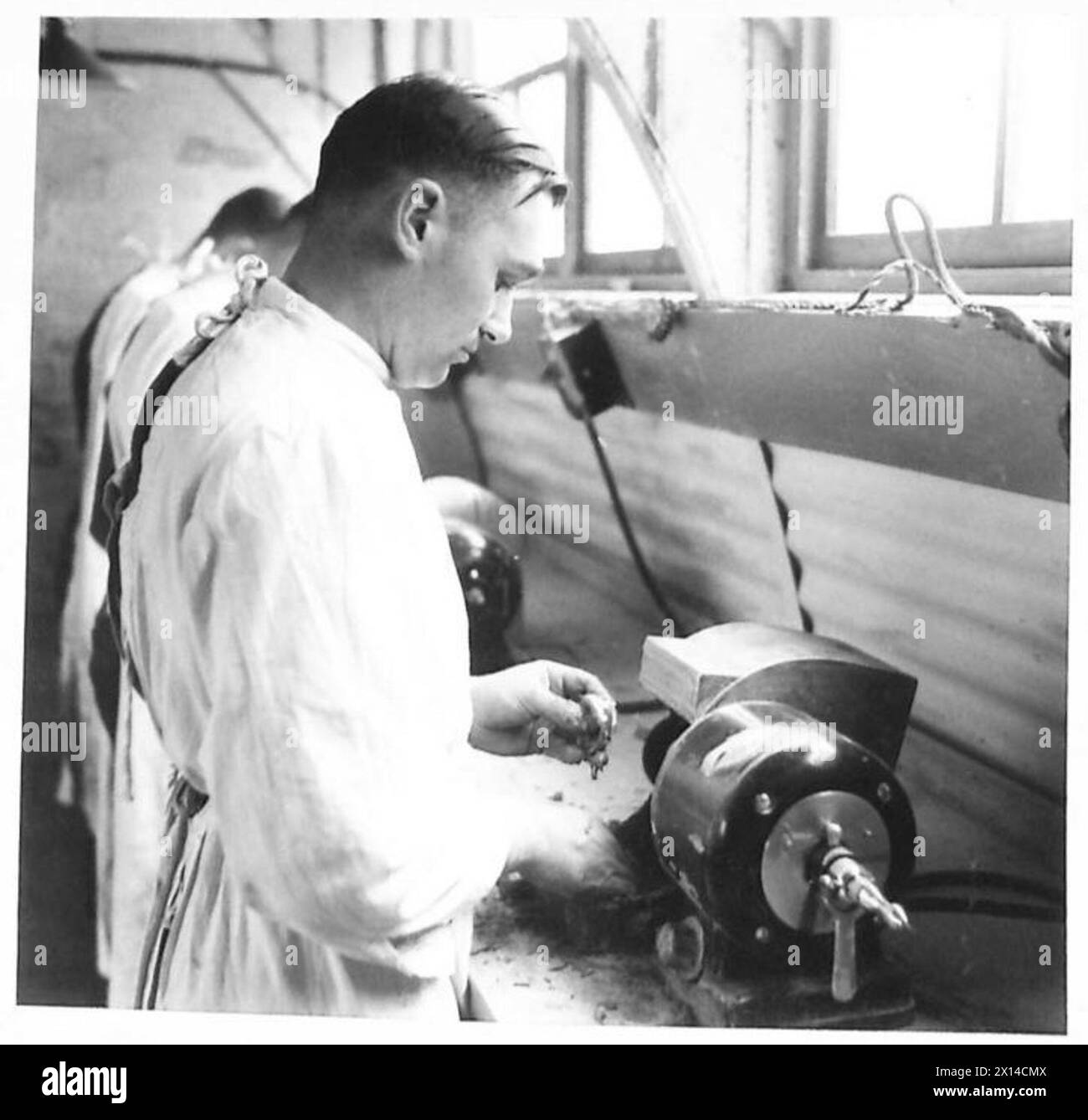 ARMY DENTAL LABORATORY - Men polishing dentures in the polishing room ...