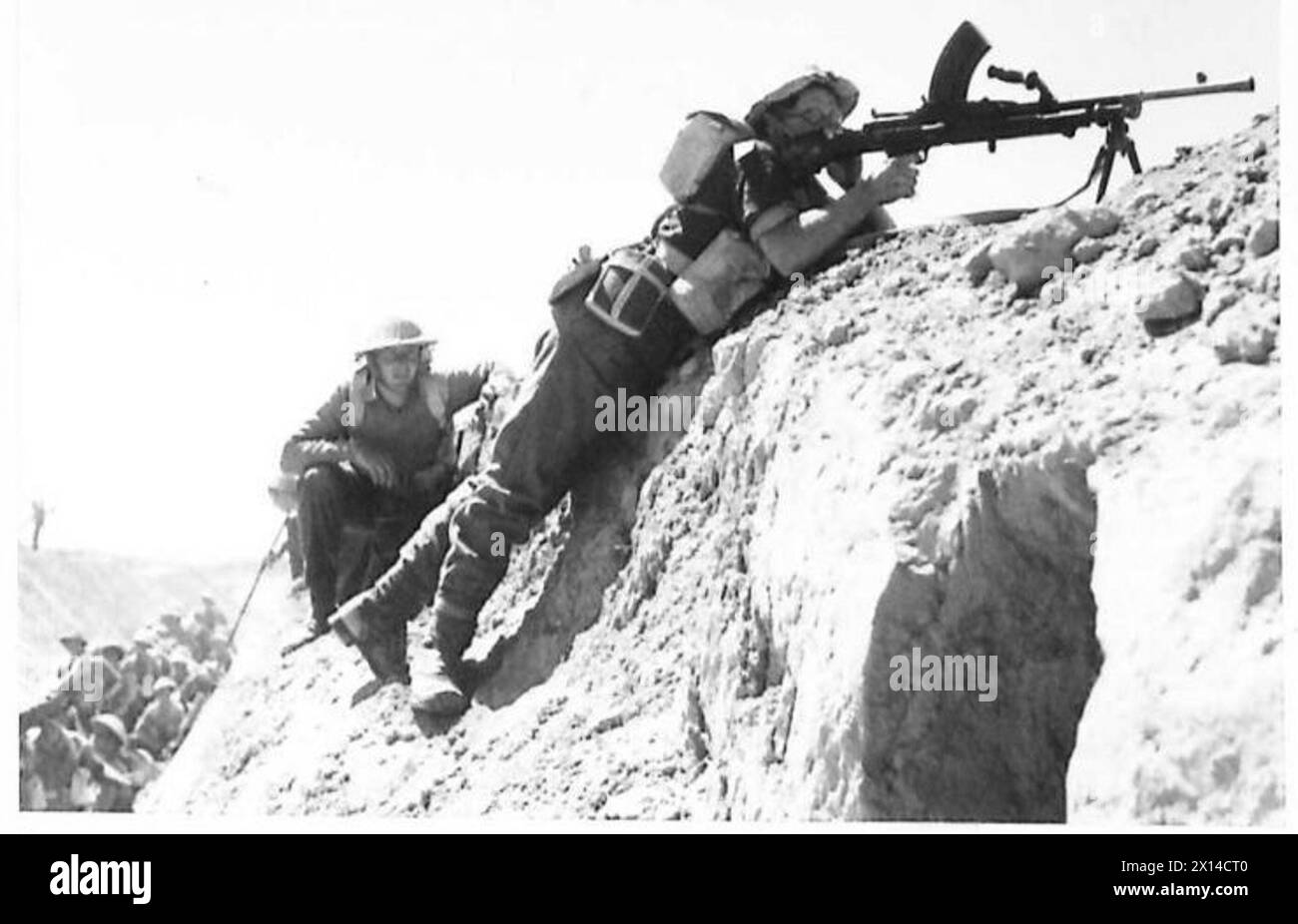 A Bren gunner provides covering fire while infantry negotiates a ditch ...