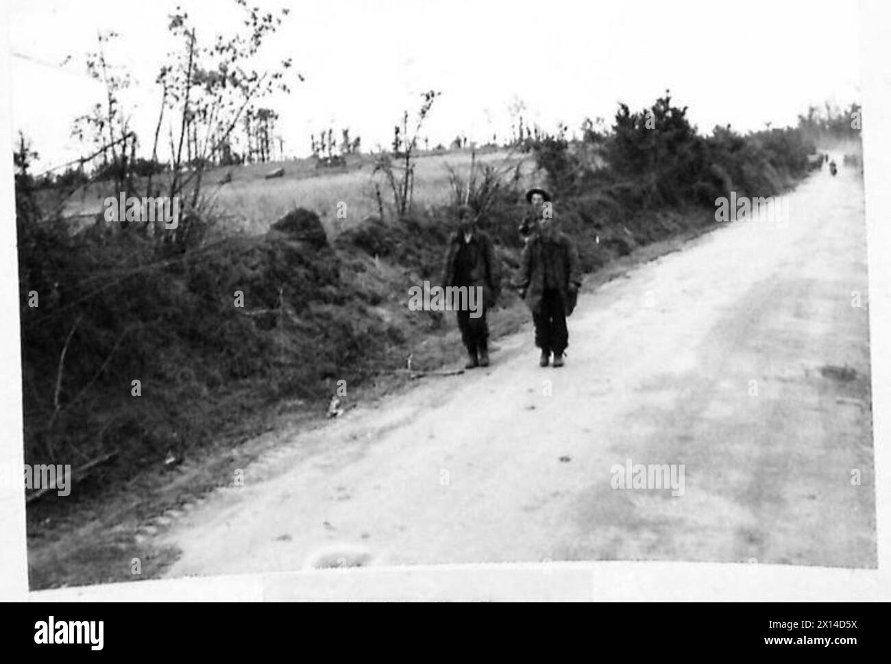 German prisoners captured at Caen are marched to a Prisoner of War cage ...
