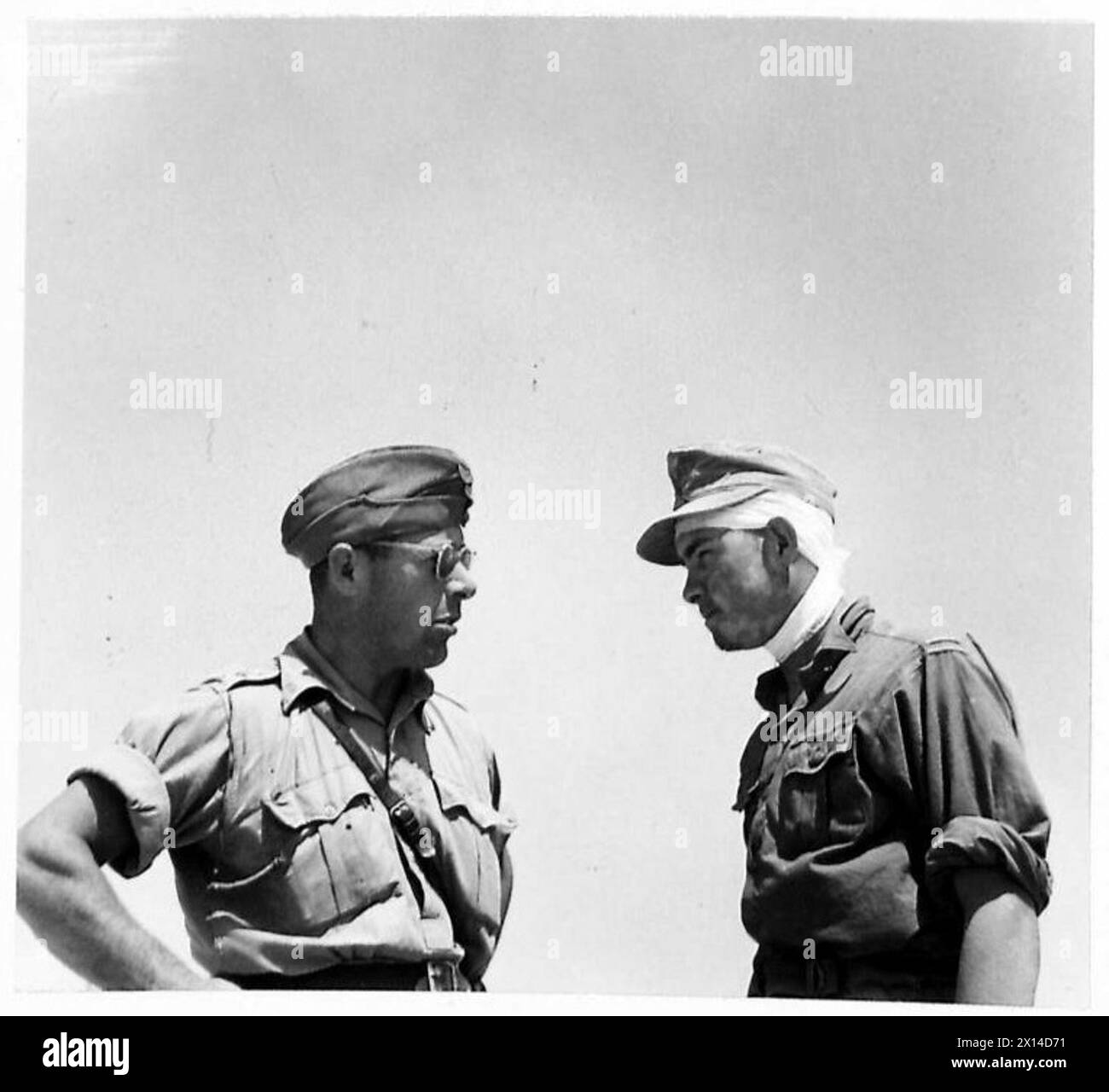 A British officer interrogates a recently captured wounded German ...