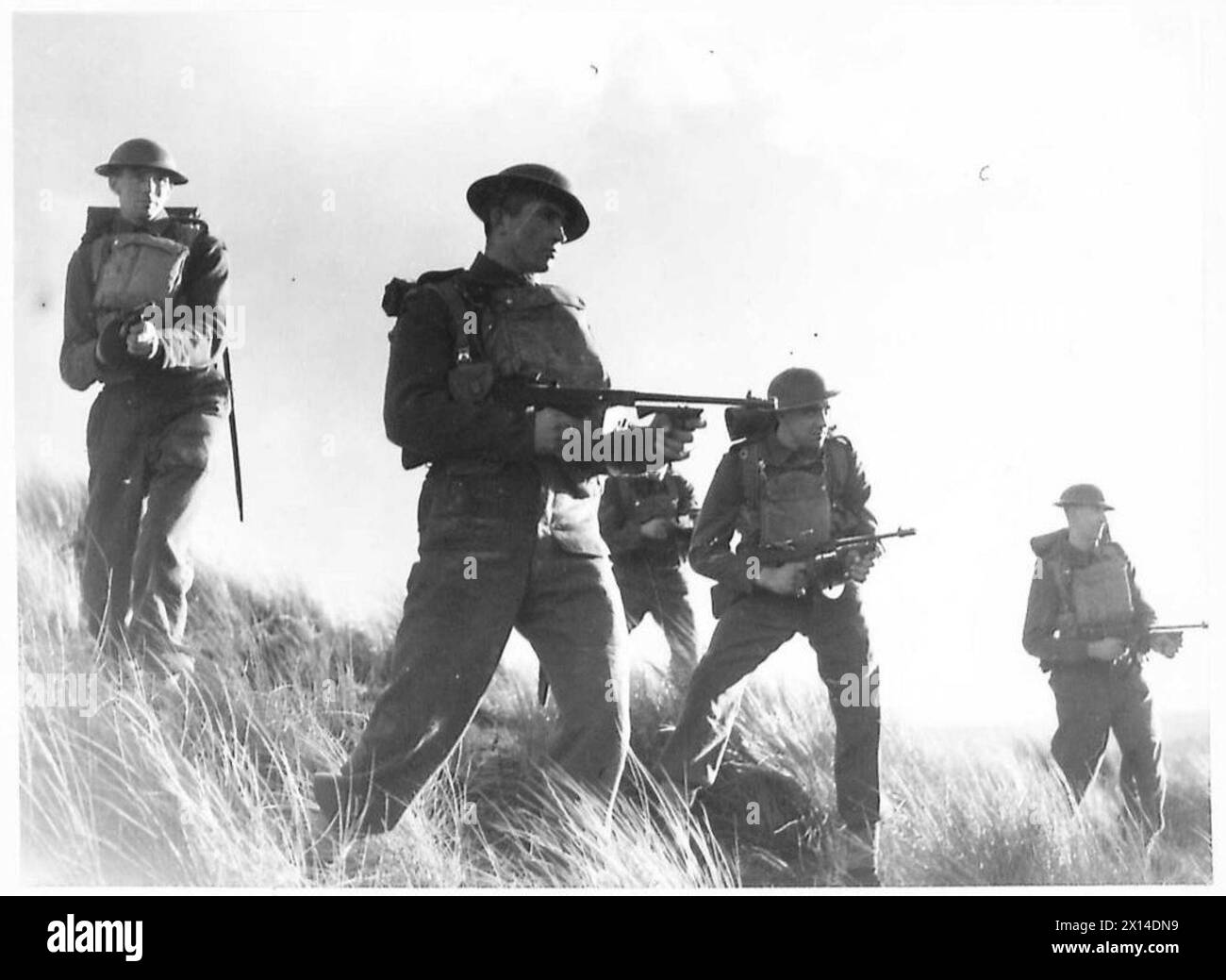 Grenadier Guards conduct realistic training exercises, armed with submachine guns, executing a ...