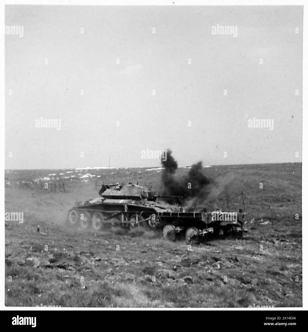A Covenanter tank moves through a Sussex village minefield, detonating ...