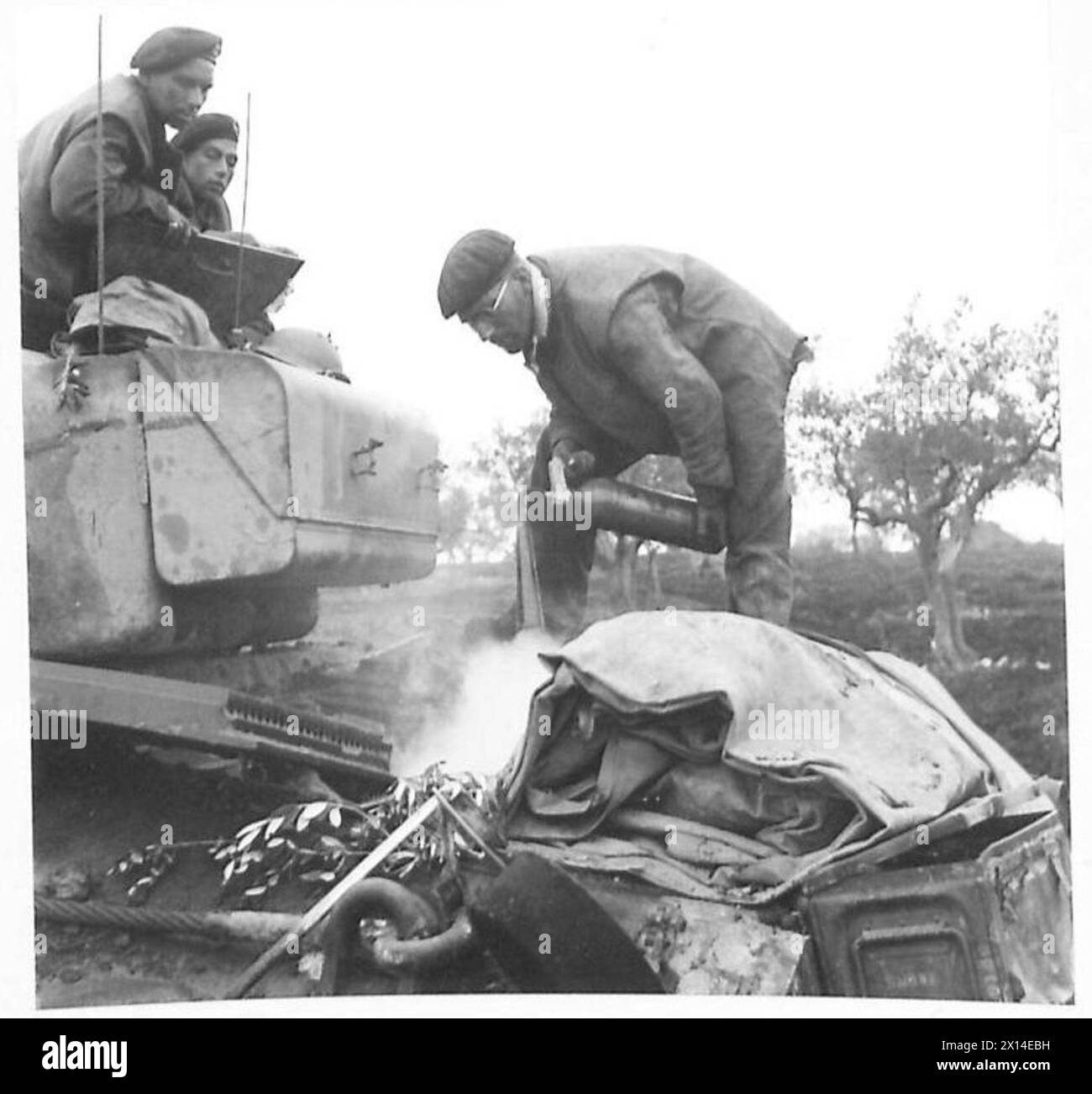A British Sherman tank of the 50th R.T.R. receives an engine hit from a ...