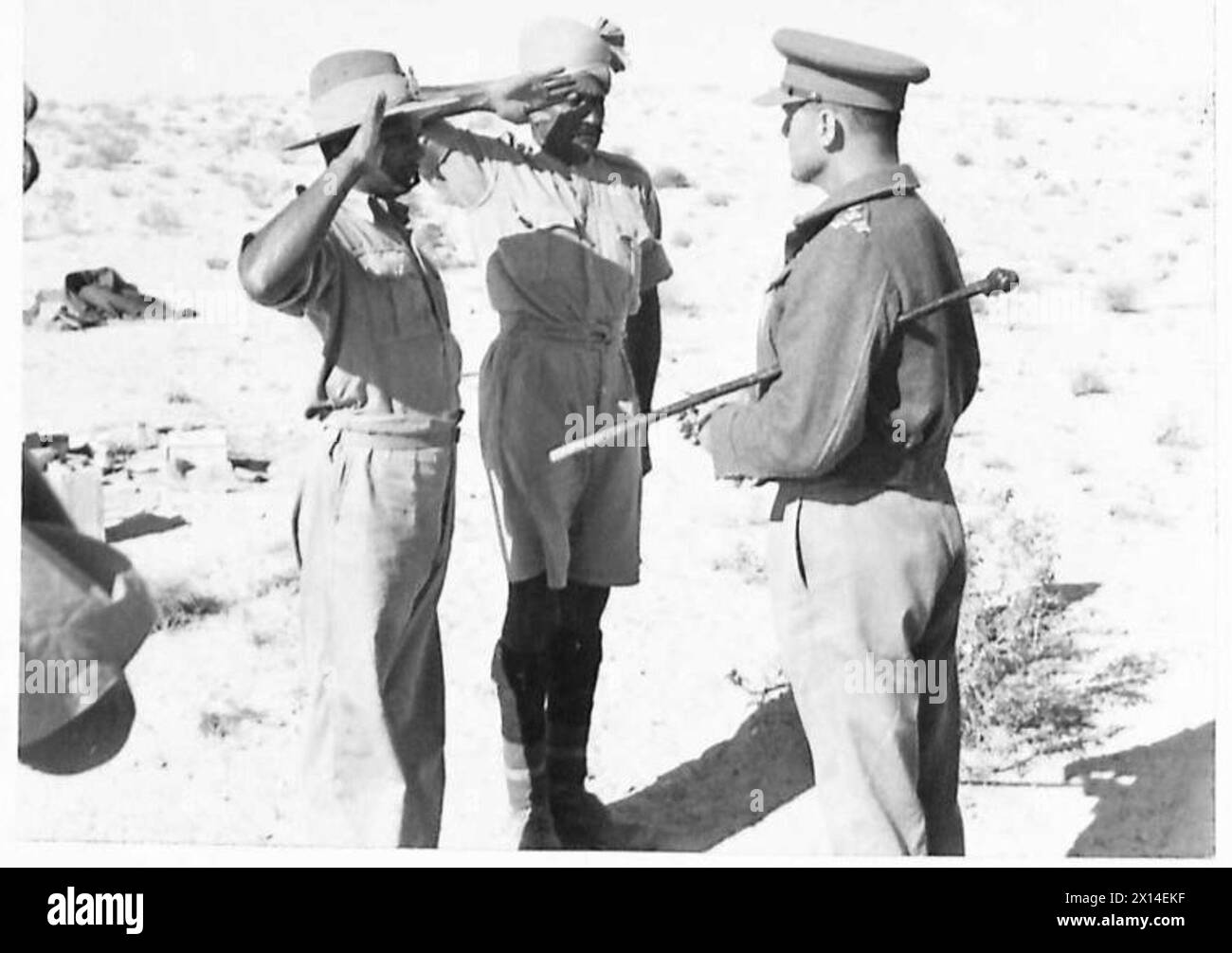 Two Indian troops salute Brigadier R.A. Savory during operations in the ...