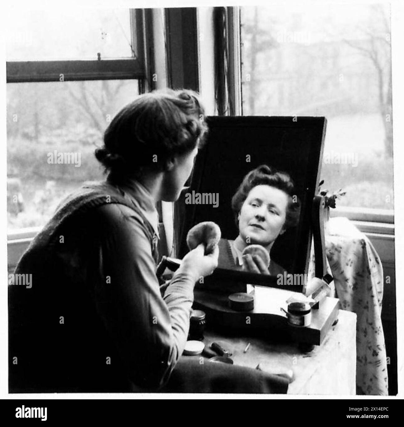 An ATS Red Cap prepares her personal appearance before going on parade ...