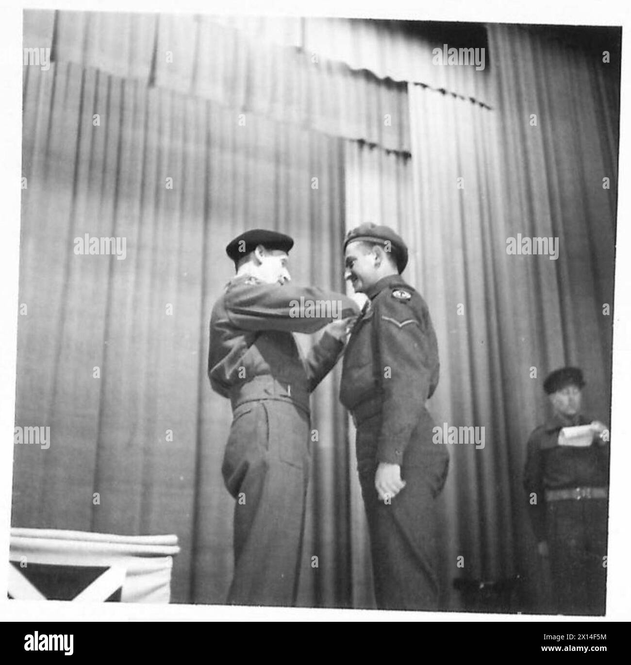 INVESTITURE 12 Corps Troops - Gnr. H.G. Cubbon, 7 Svy Regt RA receives ...