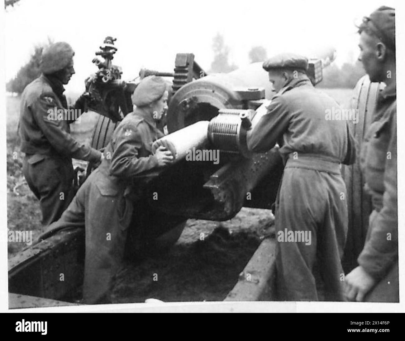 7.2 HOWITZER GUN IN ACTION - The charge of 25 lbs being placed in the ...