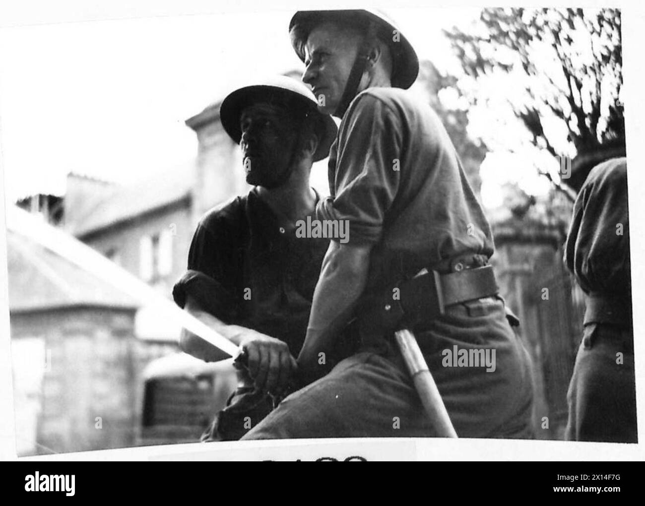 THE ARMY FIRE SERVICE - Two members of the team manning a hose at the ...