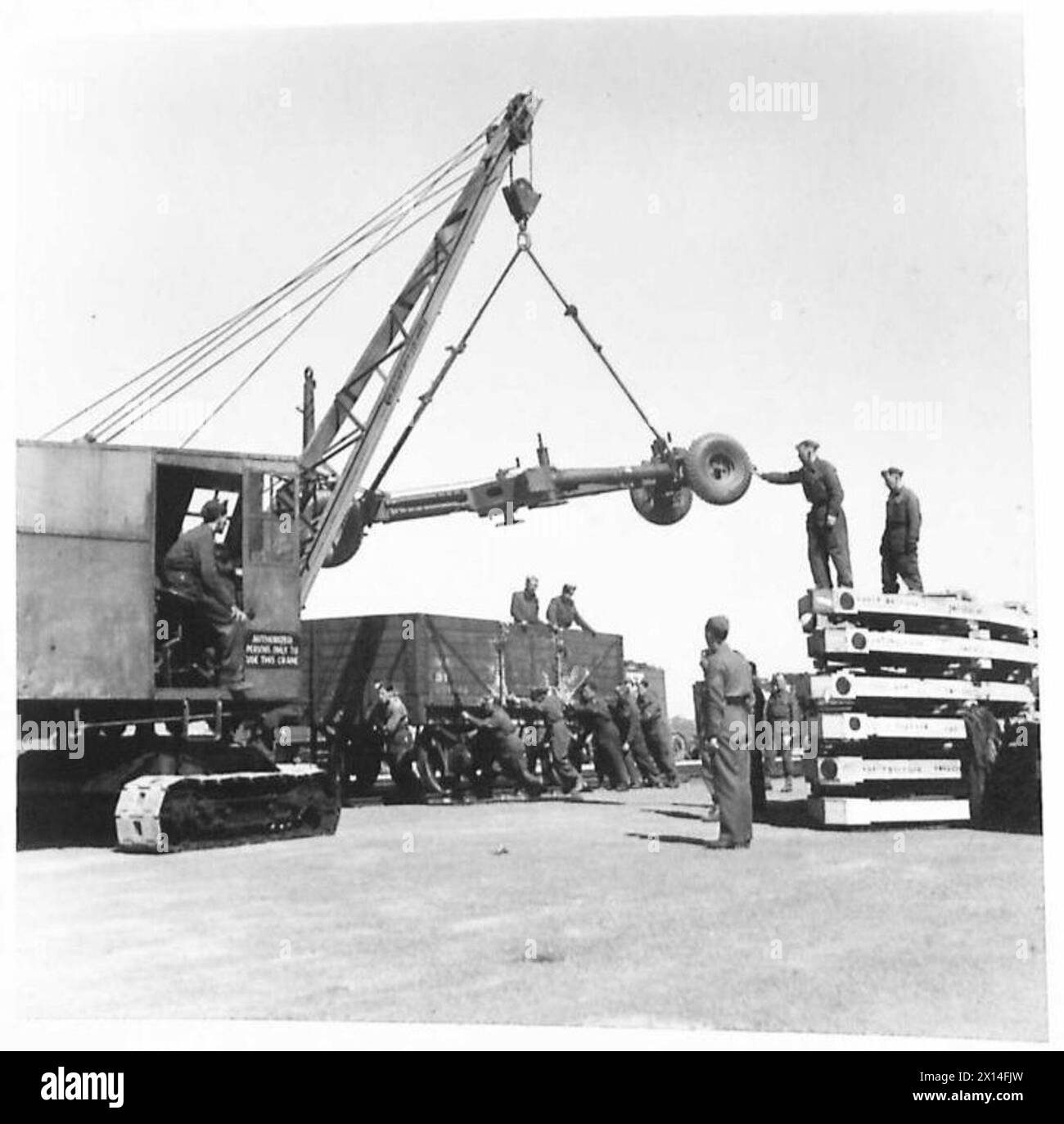 IN AN ORDNANCE DEPOT - RAOC personnel loading Bofors carriers into ...