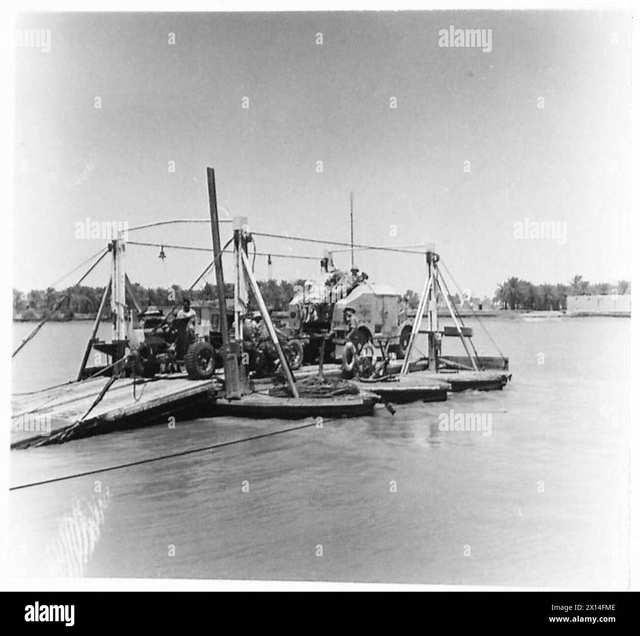 Artillery guns are ferried across a river in Persia during British Army ...