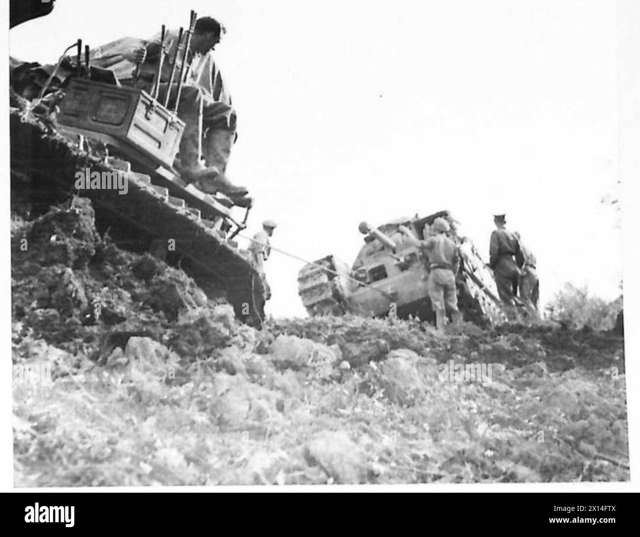 EIGHTH ARMY : AFTER THE RAINS - The tractor slowly pulls the tank out ...