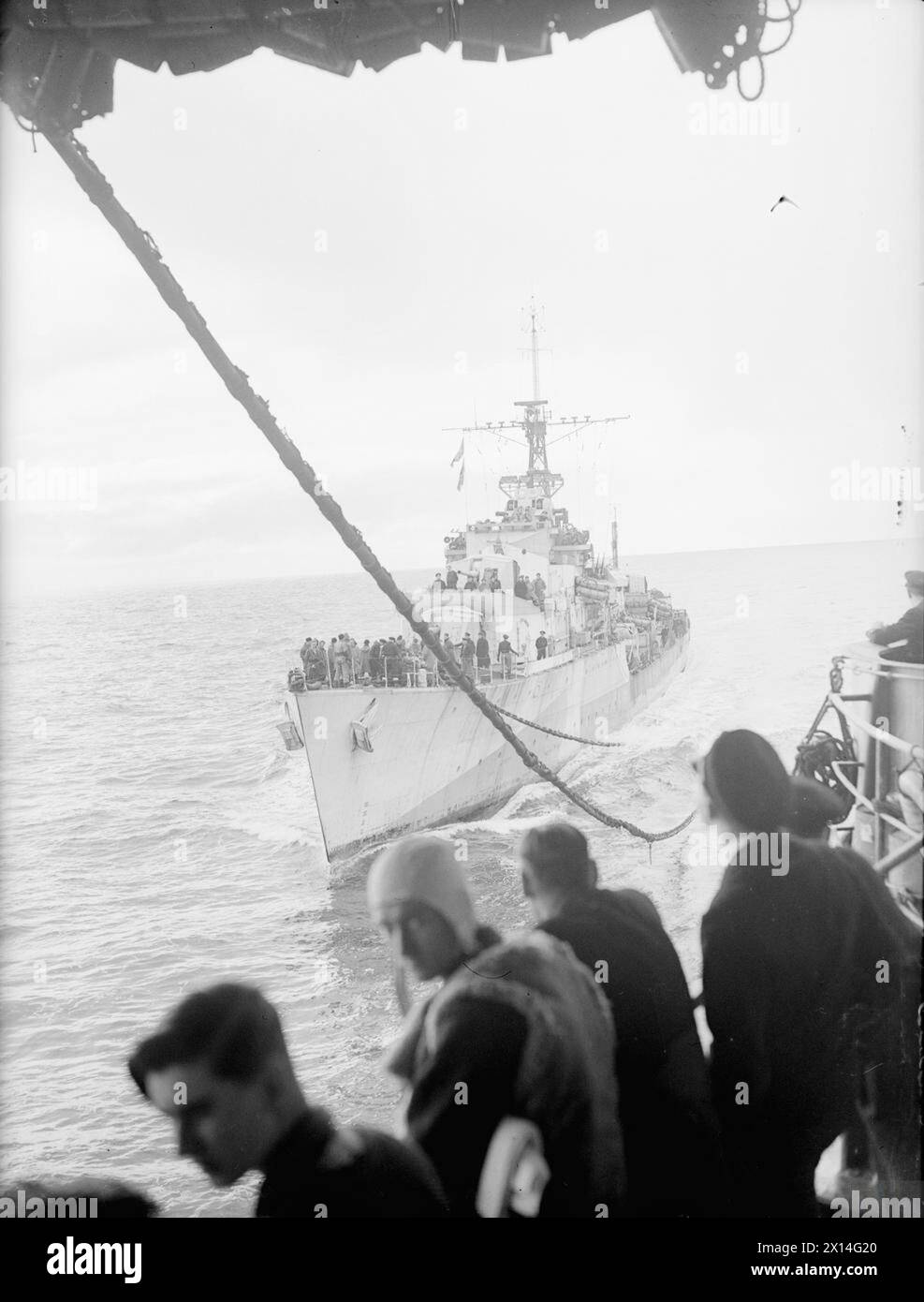 OILING A DESTROYER AT SEA. AUGUST 1944, ON BOARD HMS TRUMPETER DURING ...