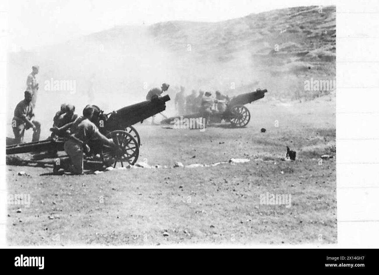 BRITISH GUNNERS TRAIN PARTISANS - The guns fire, in a cloud of smoke ...