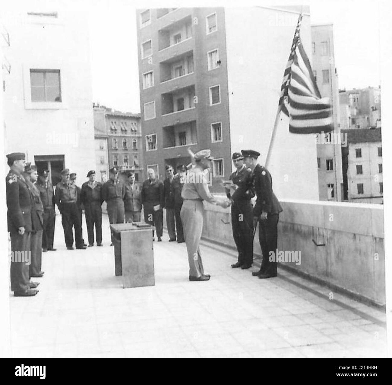 Colonel Fiske presents Major E. Hill of the Legal Division, AMG, with ...
