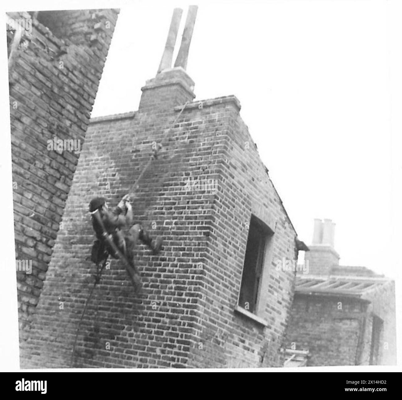 A trainee of the Army Physical Training Corps demonstrates scaling the ...
