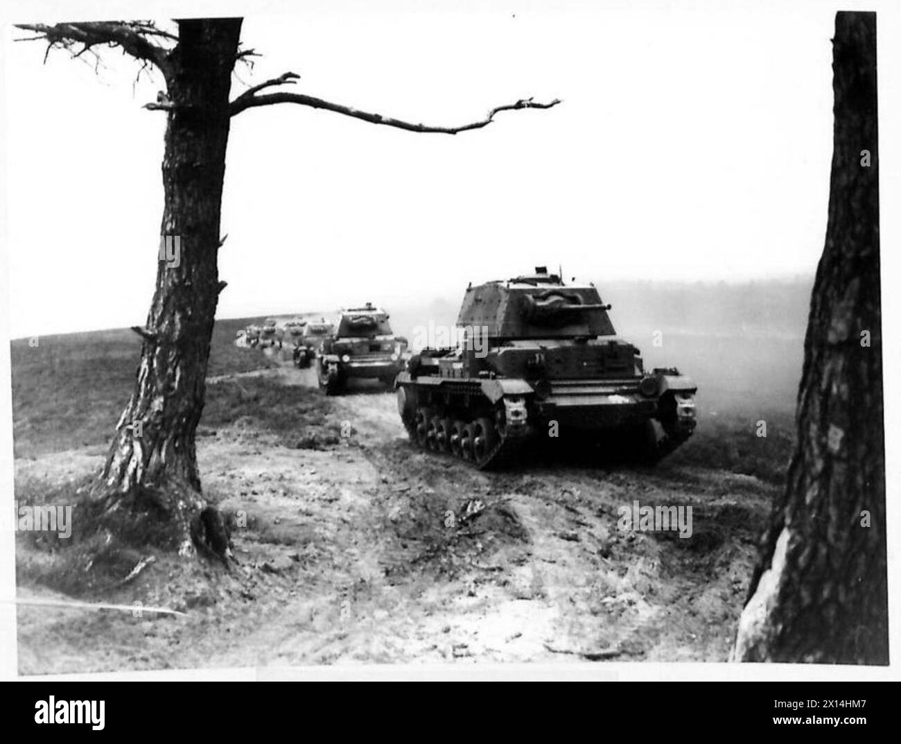 A DAY WITH THE ROYAL TANK REGIMENT - A line of tanks crossing a common ...