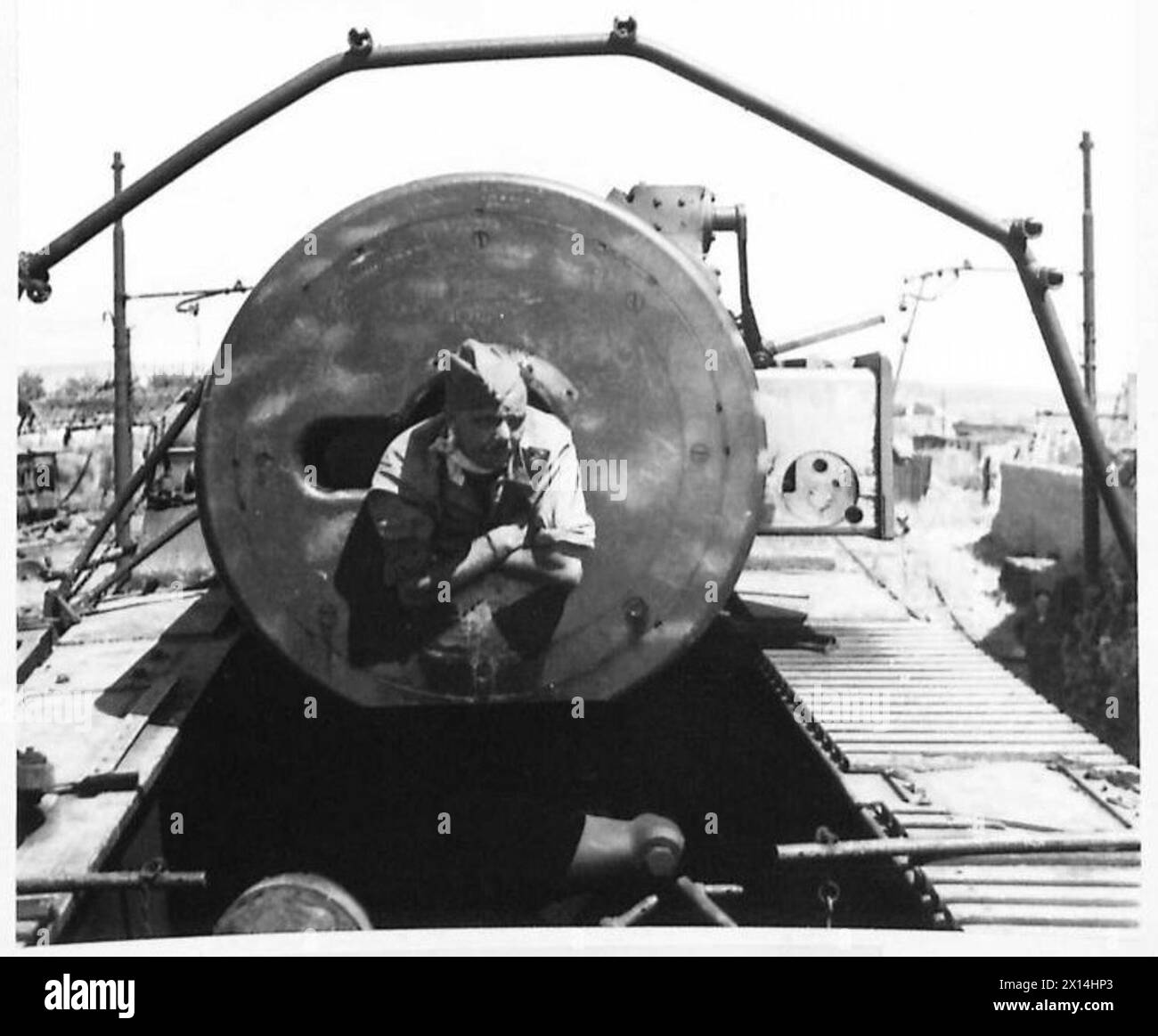 Sgt. R. Spittle demonstrates the bore size of a long-range artillery ...