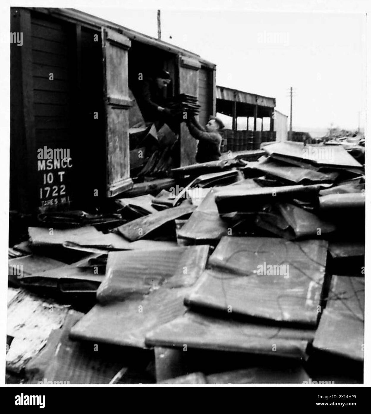 AT A NORTHERN IRELAND ARMY SALVAGE DEPOT - Loading a railway truck with ...