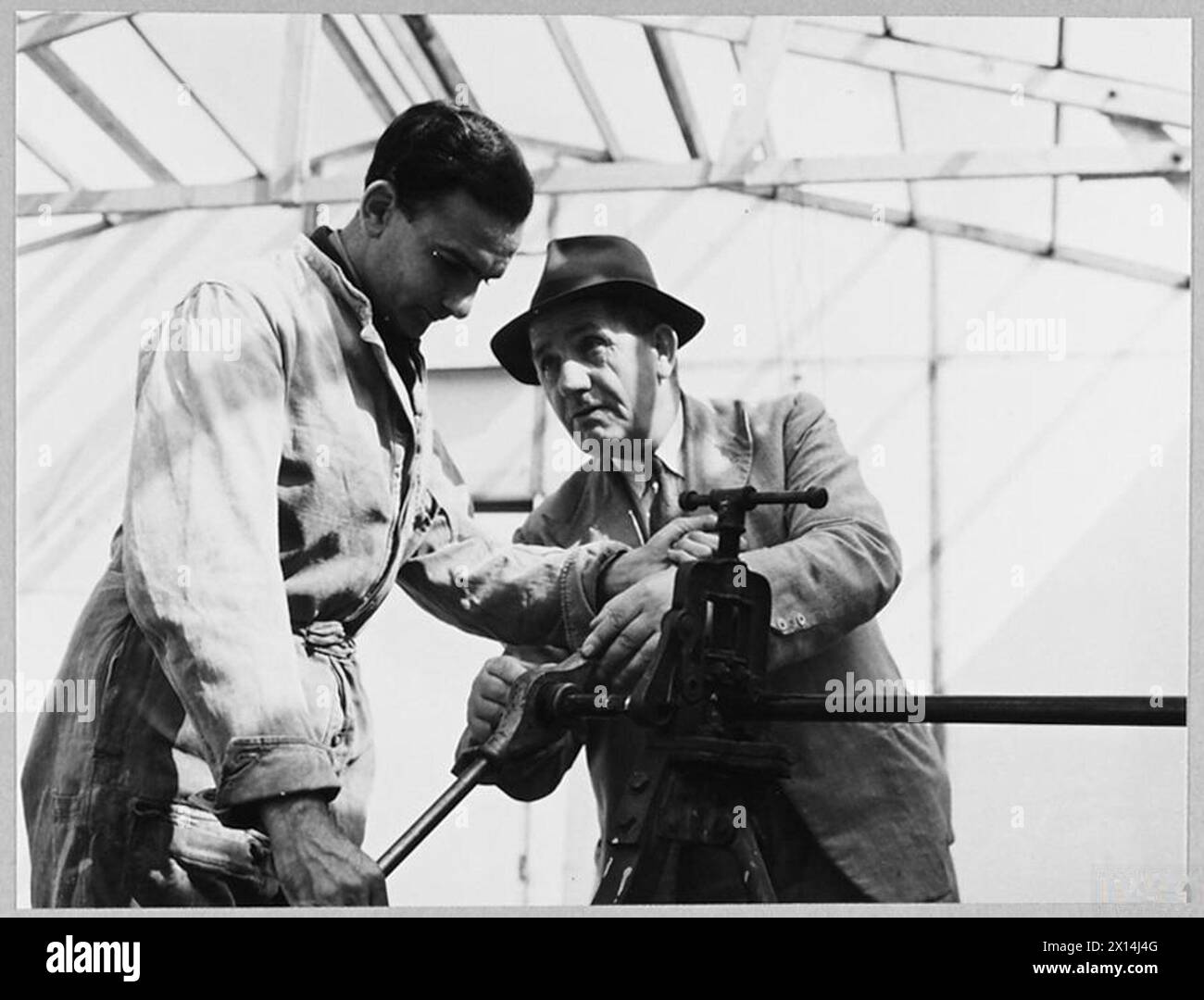 Foreman Charles Rossiter instructs Corporal R. Dunham, fitter, on ...
