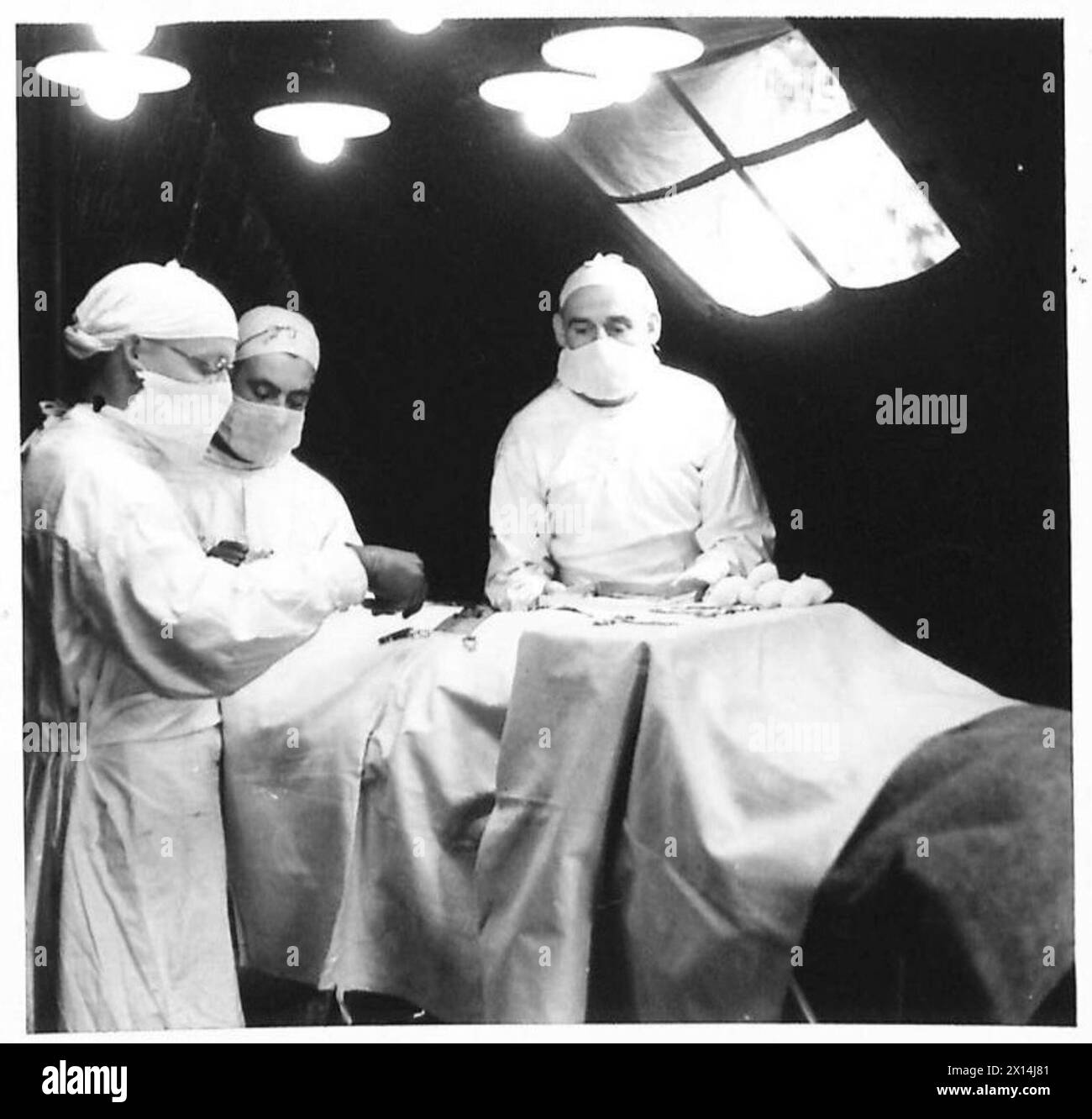 Royal Army Medical Corps personnel conduct a medical operation in a ...
