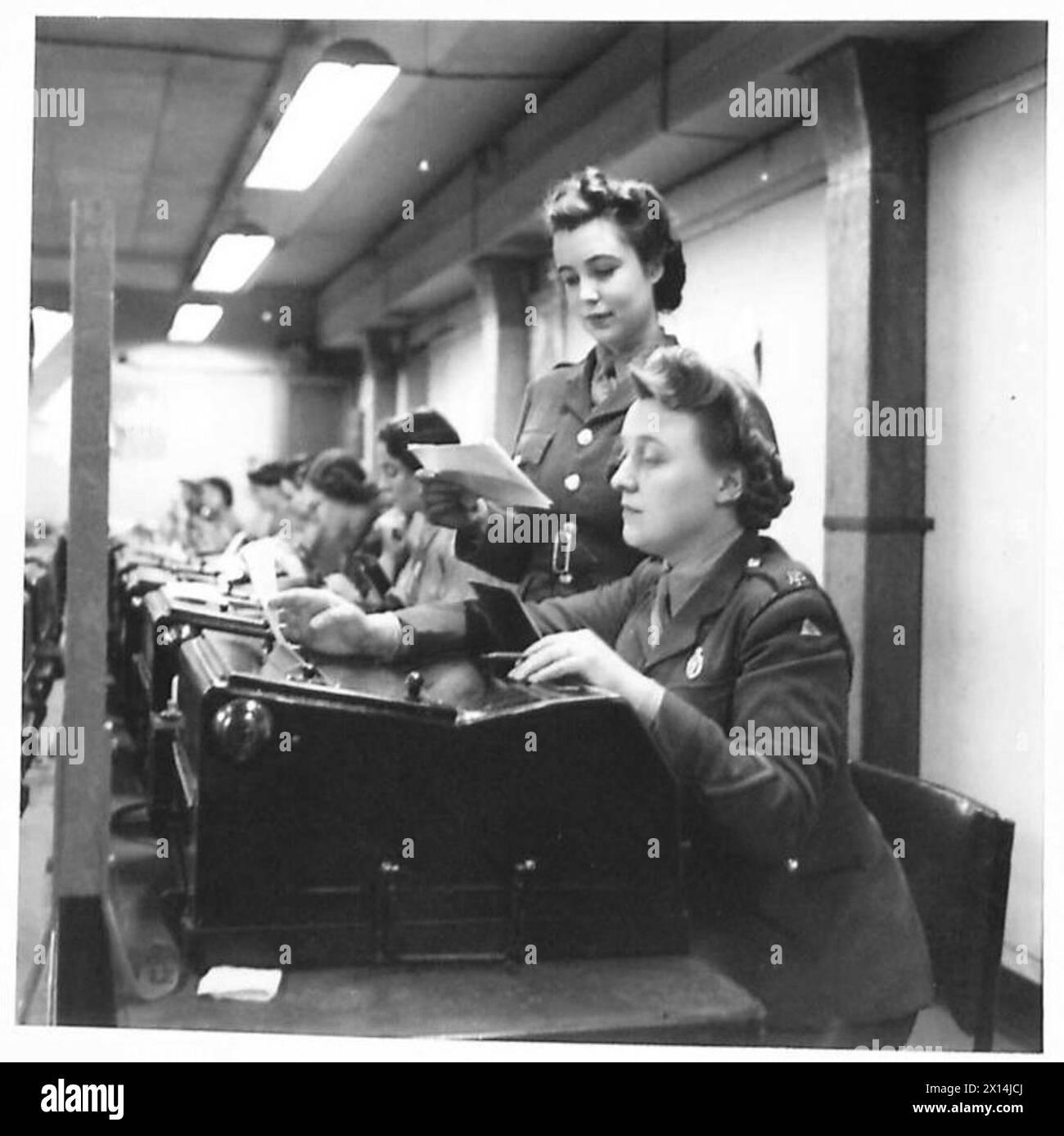 ATS TELEPRINTER OPERATORS - Pte. A. Chapman (nearest camera) and Pte. D. Brown check over ...