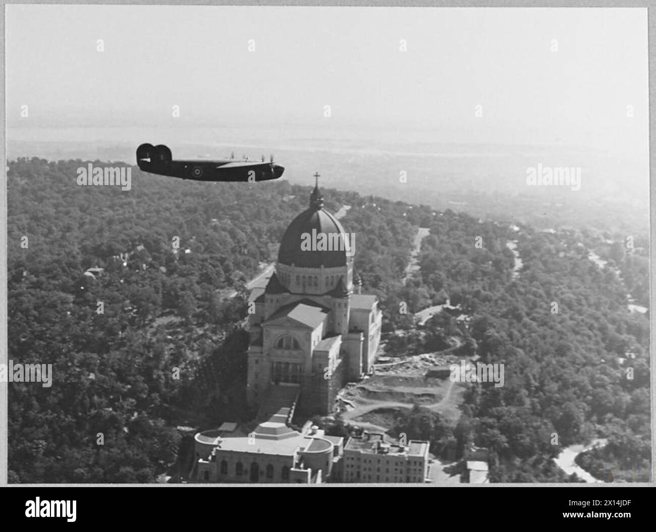 A BOAC Liberator aircraft flies past St. Joseph's Shrine before landing ...