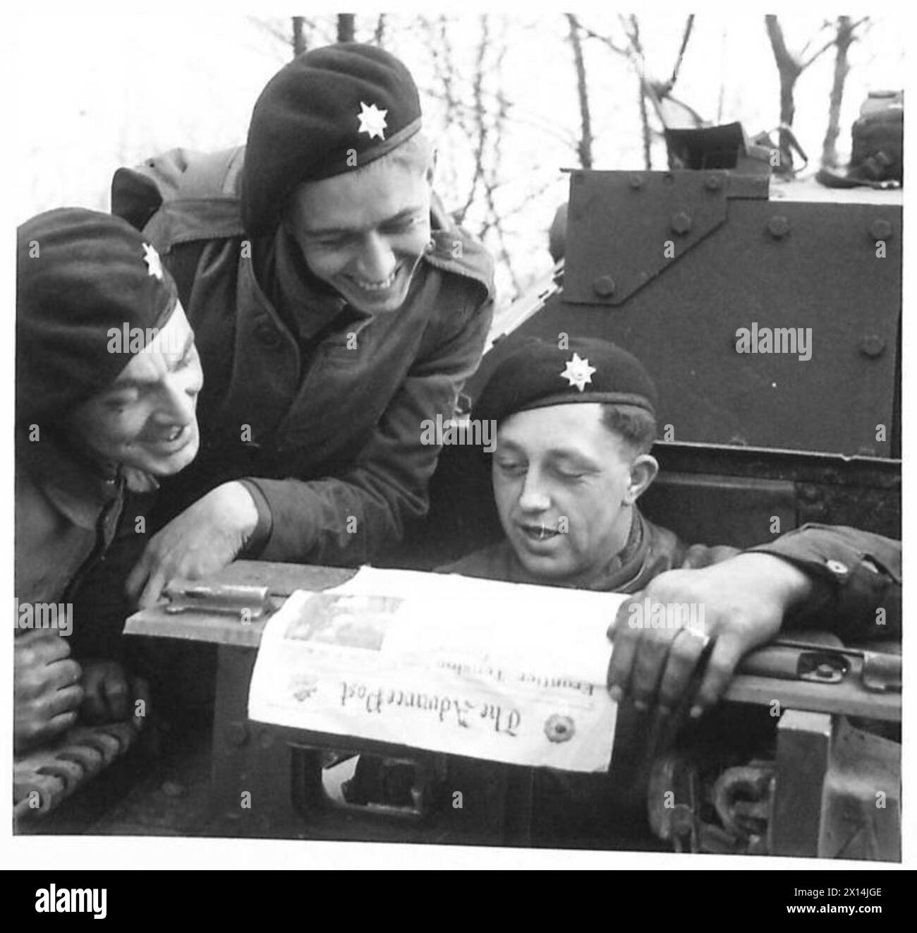 Tank crews from the Guards Armoured Division read the 'Advance Post ...